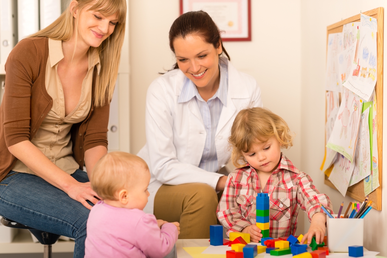 Visit at pediatrician two little children play at medical office ...